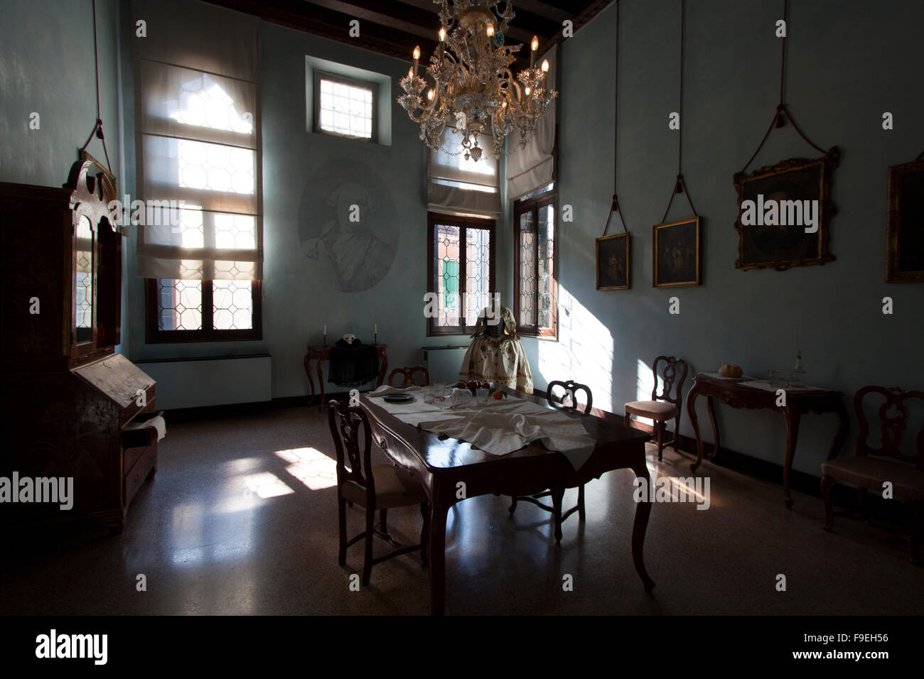 Table laid out for dinner in a room with lots of windows Stock Photo ...