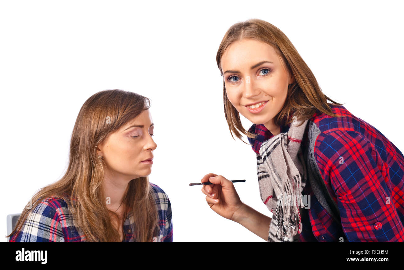 Makeup artist apply makeup to a model , isolated on white Stock Photo ...
