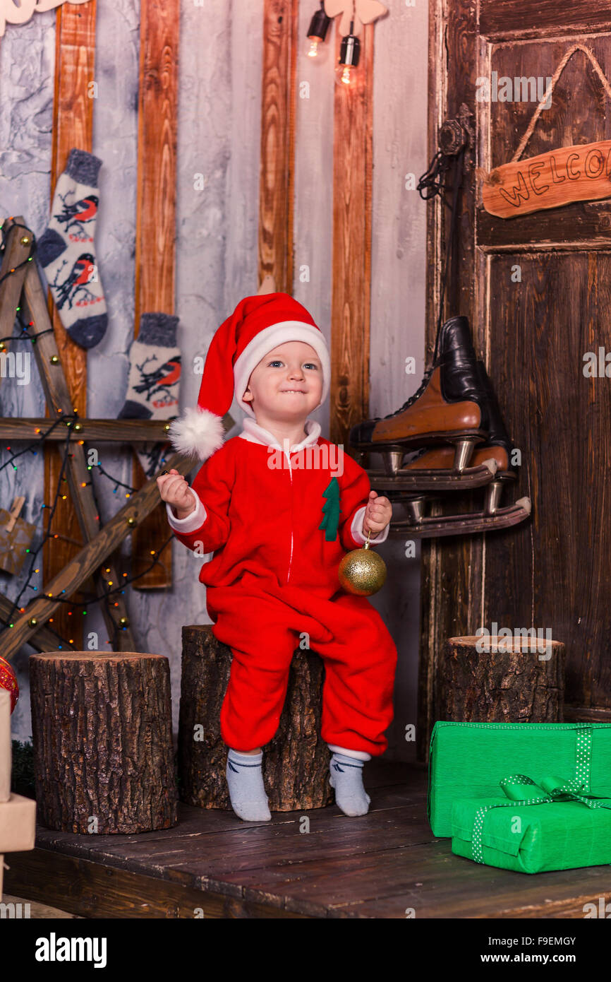Happy cute little baby in Santa's costume near Xmas tree Stock Photo ...