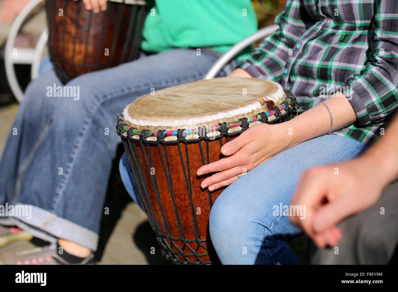woman playing on Africa Jambe Drum Stock Photo - Alamy