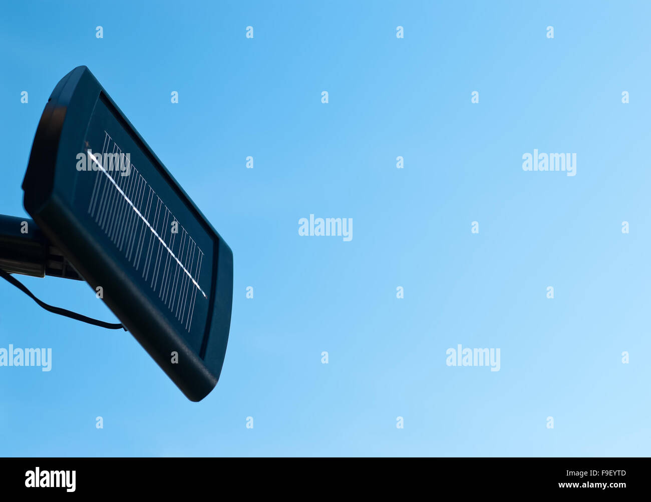 Household battery. Small solar panel on the background of blue sky ...