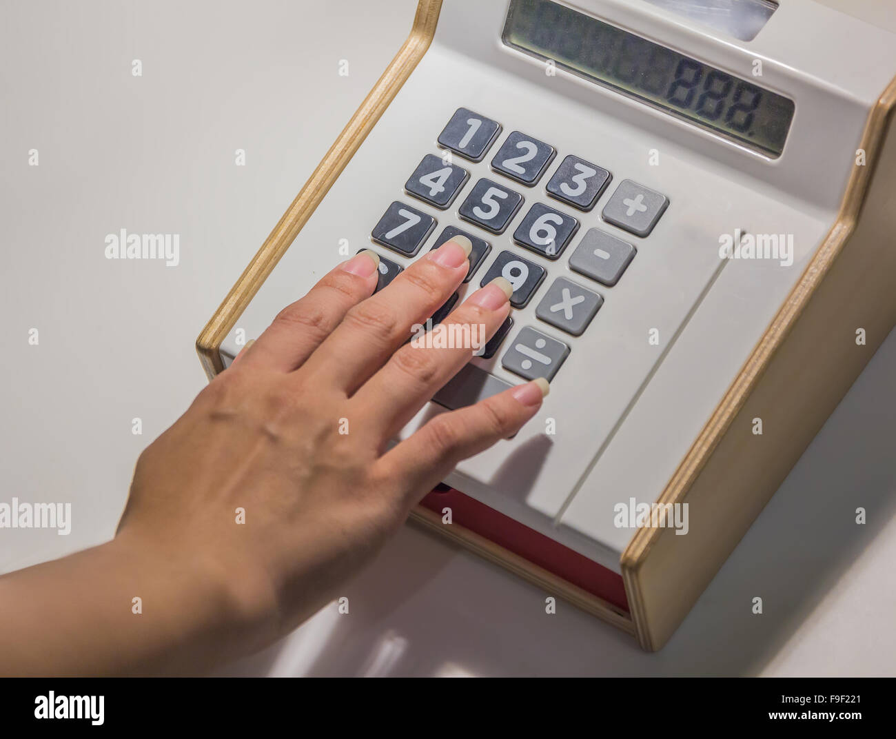 closeup oh hand with calculator on desk background Stock Photo - Alamy