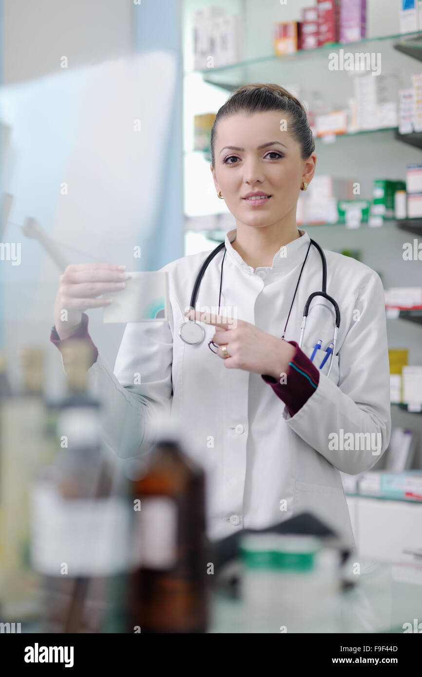 Happy cheerful pharmacist chemist woman standing in pharmacy drugstore ...