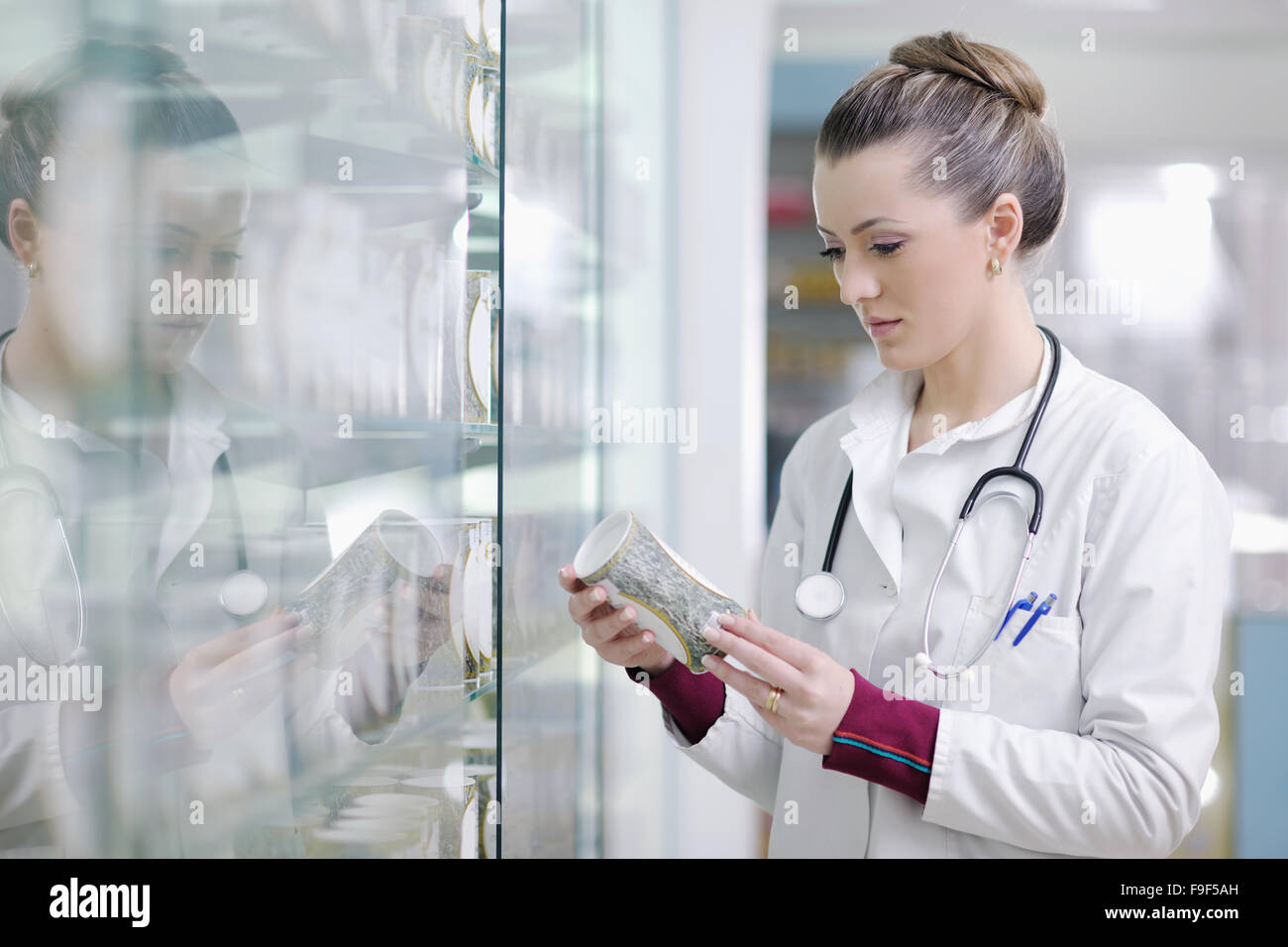Happy cheerful pharmacist chemist woman standing in pharmacy drugstore ...