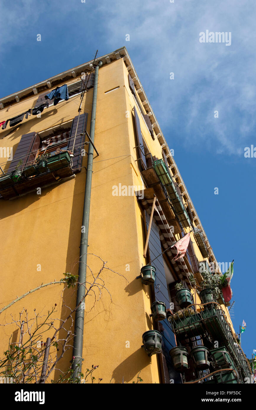 Yellow building and blue sky from a low angle Stock Photo - Alamy