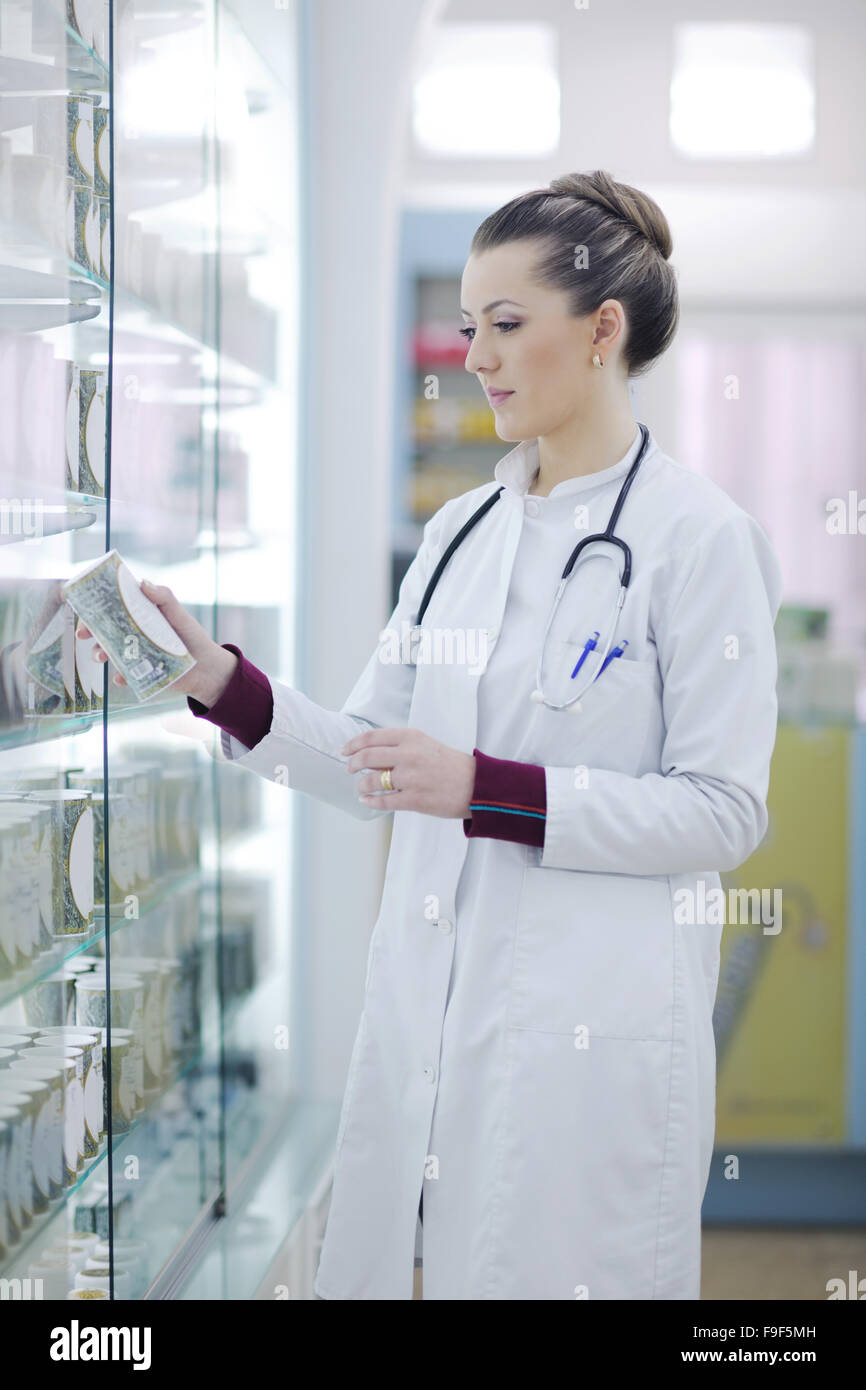 Happy cheerful pharmacist chemist woman standing in pharmacy drugstore ...