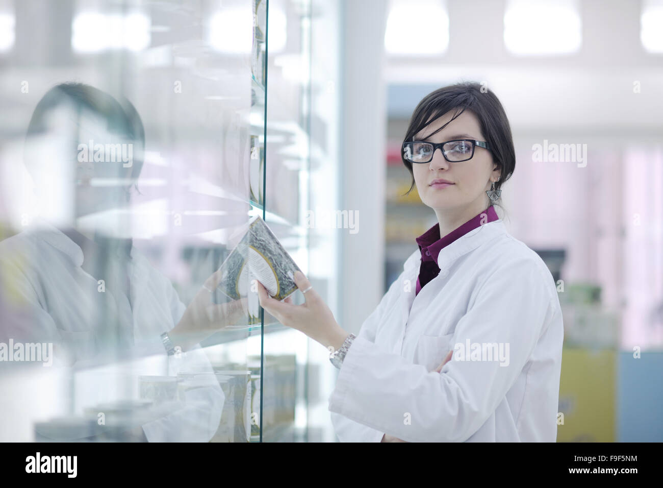 Happy cheerful pharmacist chemist woman standing in pharmacy drugstore ...