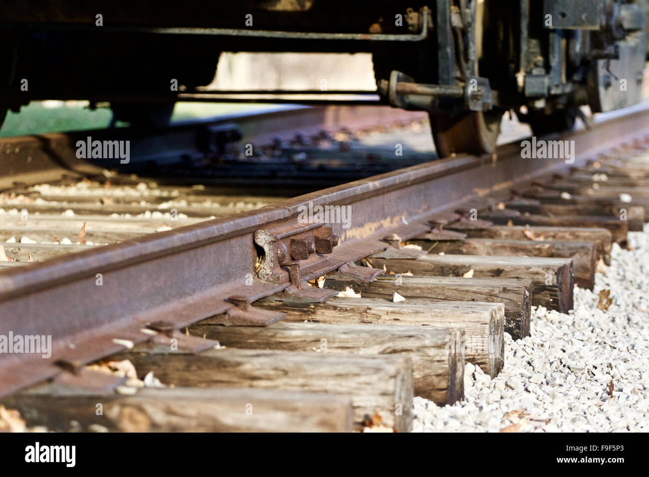 Background with the rusty railroad and coming train Stock Photo - Alamy