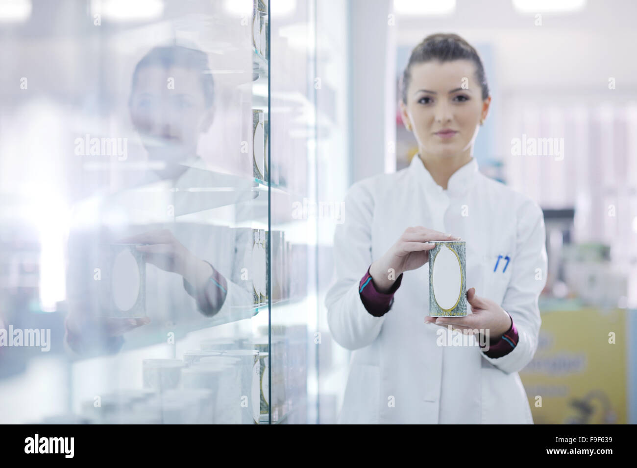 Happy cheerful pharmacist chemist woman standing in pharmacy drugstore ...