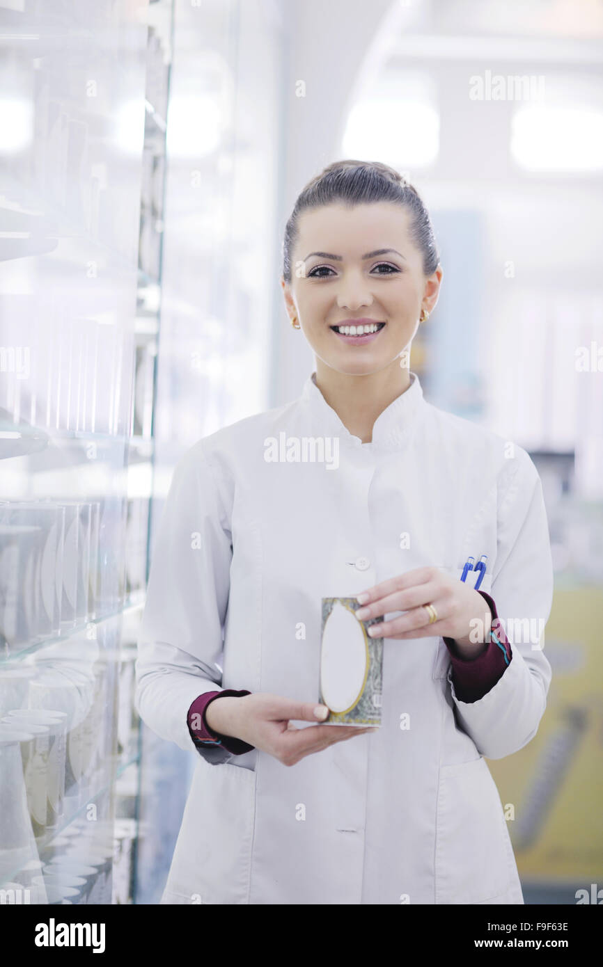 Happy cheerful pharmacist chemist woman standing in pharmacy drugstore ...