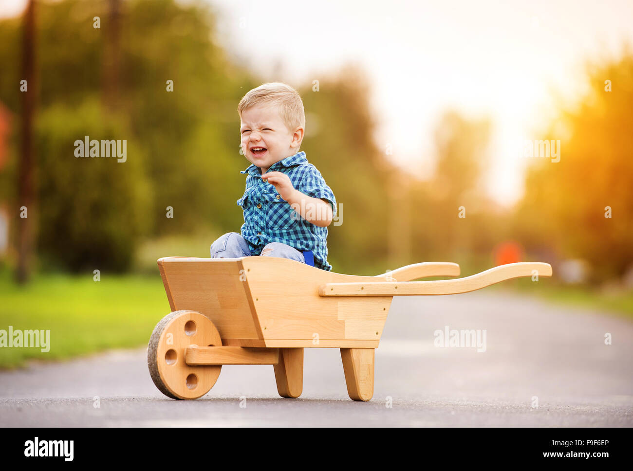 Little boy getting upset and crying while playing outside on the street ...