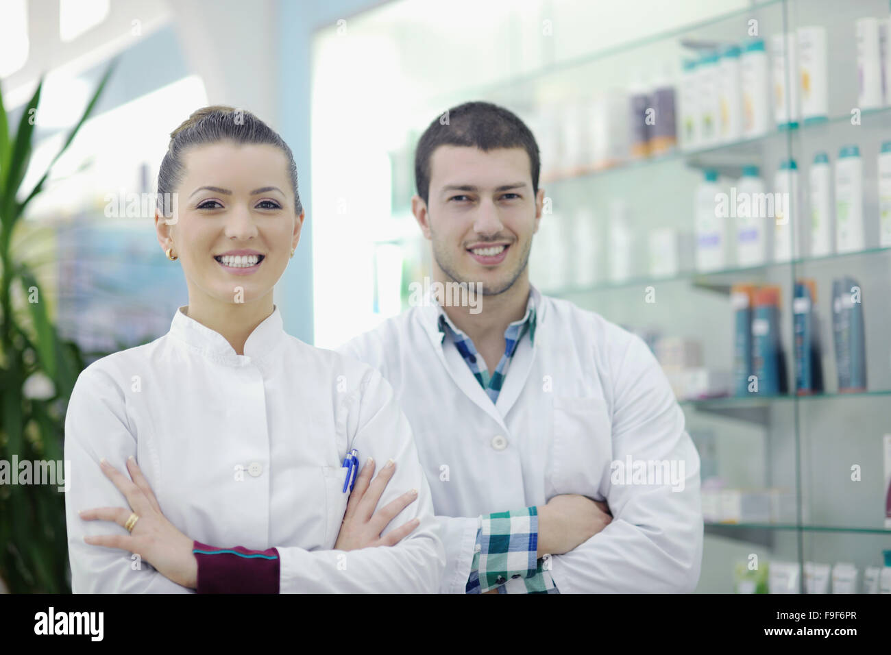 team of pharmacist chemist woman and man group standing in pharmacy ...