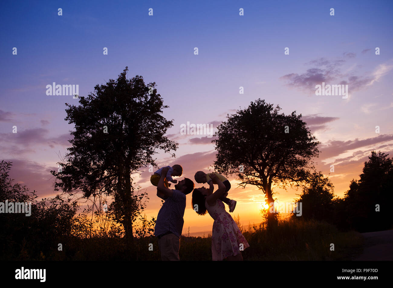 Happy young family spending time together outside in green nature Stock ...