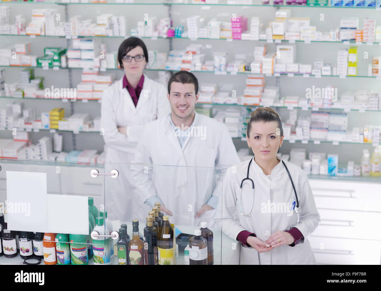 team of pharmacist chemist woman and man group standing in pharmacy ...