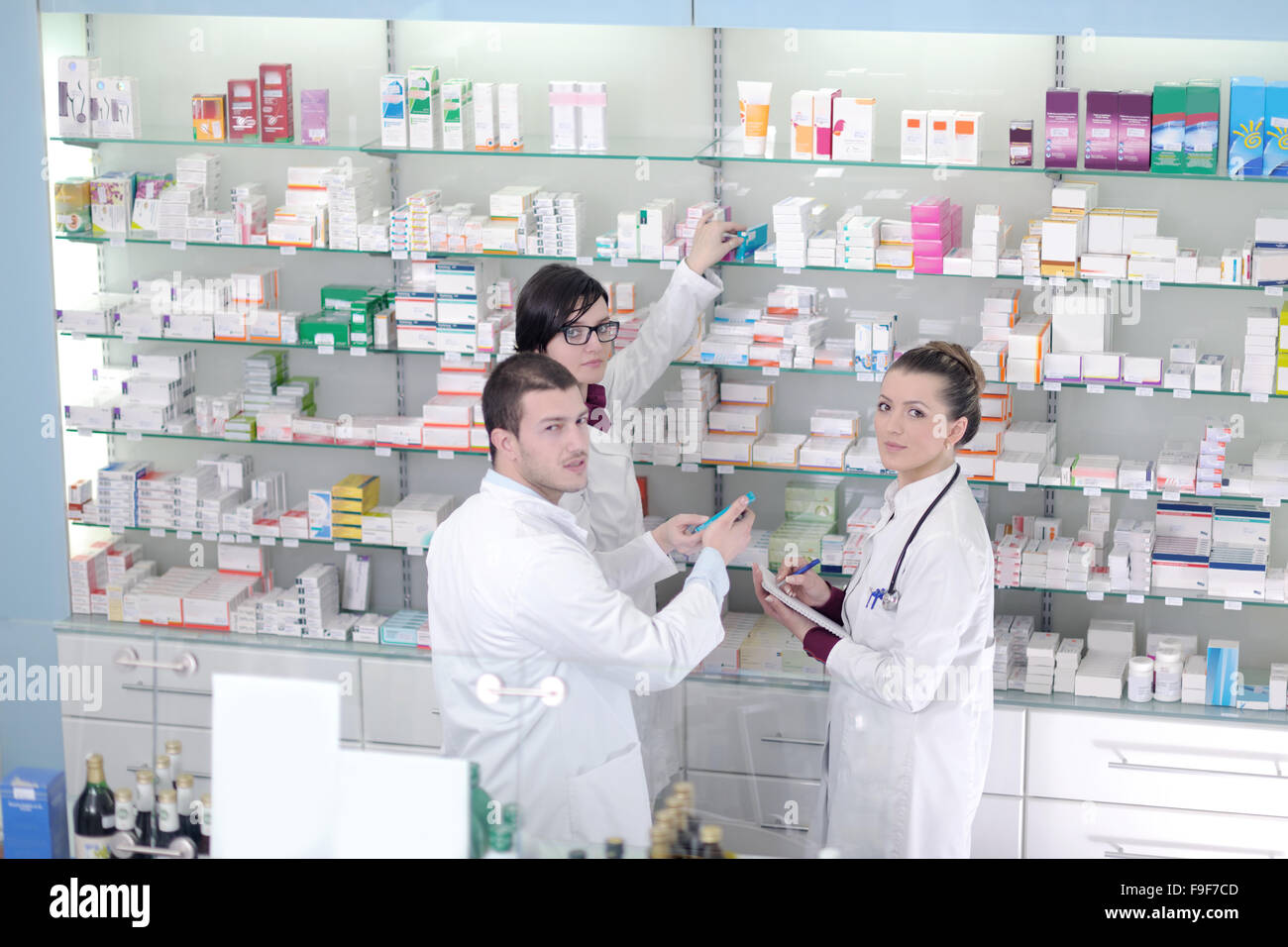team of pharmacist chemist woman and man group standing in pharmacy ...
