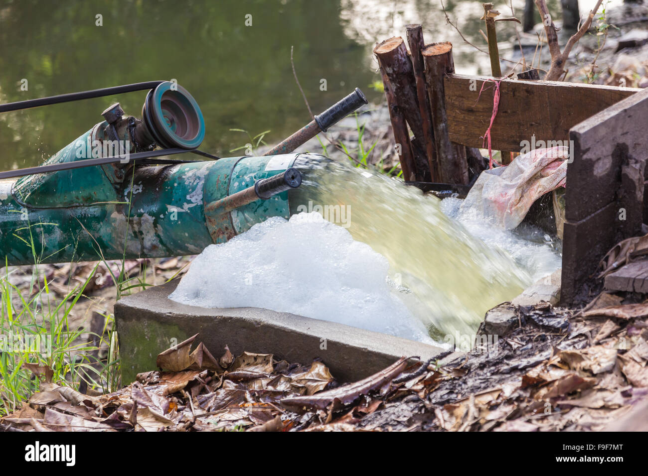 Water from a well filled a pond for irrigation Stock Photo - Alamy