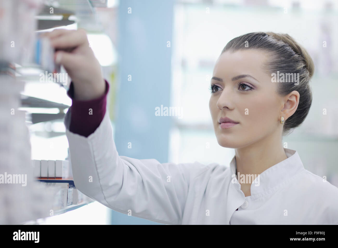 Happy cheerful pharmacist chemist woman standing in pharmacy drugstore ...