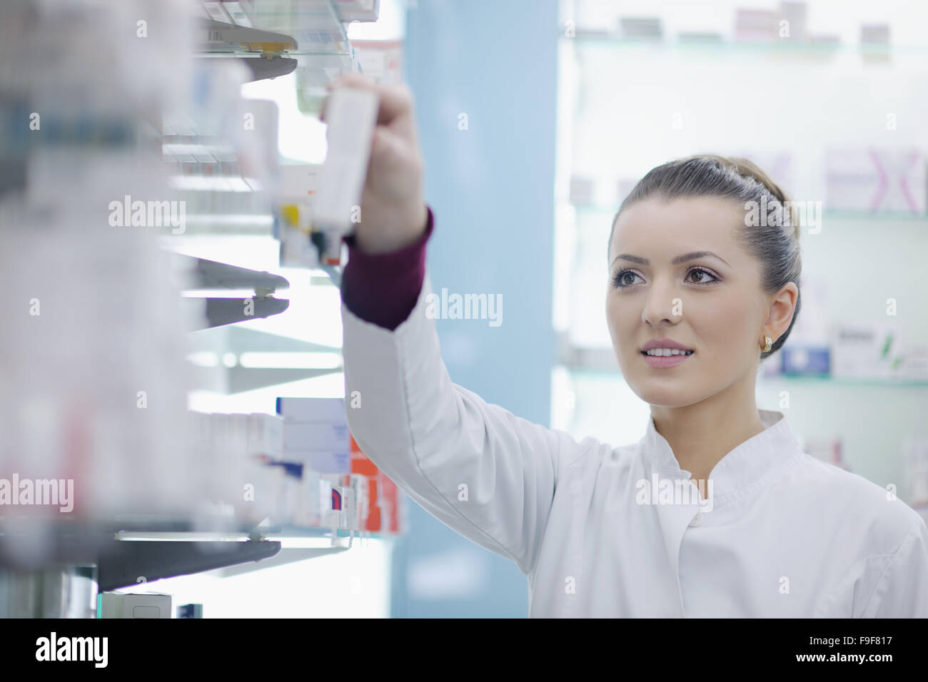 Happy cheerful pharmacist chemist woman standing in pharmacy drugstore ...