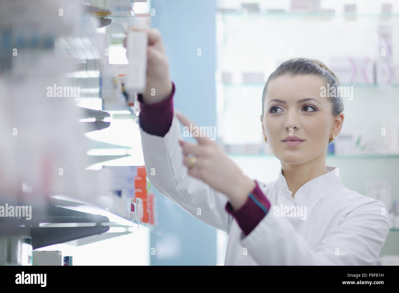Happy cheerful pharmacist chemist woman standing in pharmacy drugstore ...