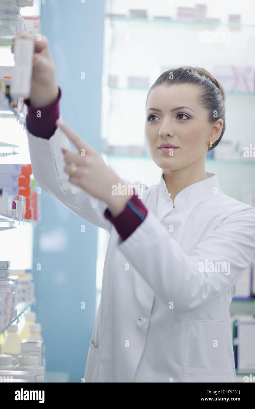 Happy cheerful pharmacist chemist woman standing in pharmacy drugstore ...