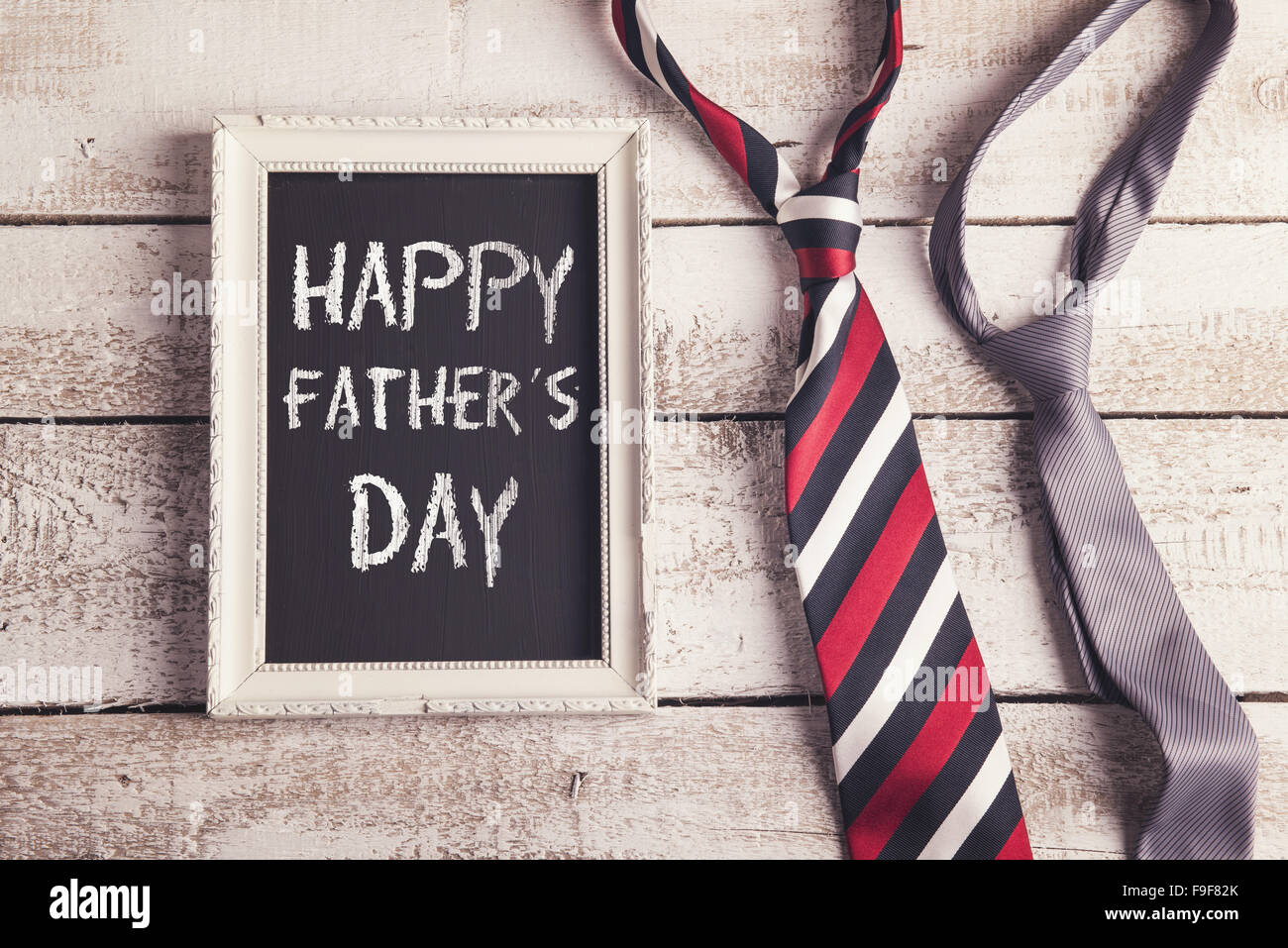 Rectangle picture frame with Happy fathers day sign and two ties laid ...