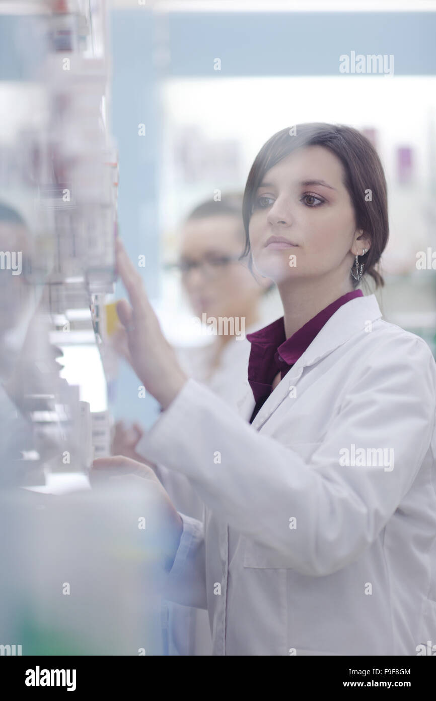 Happy cheerful pharmacist chemist woman standing in pharmacy drugstore ...