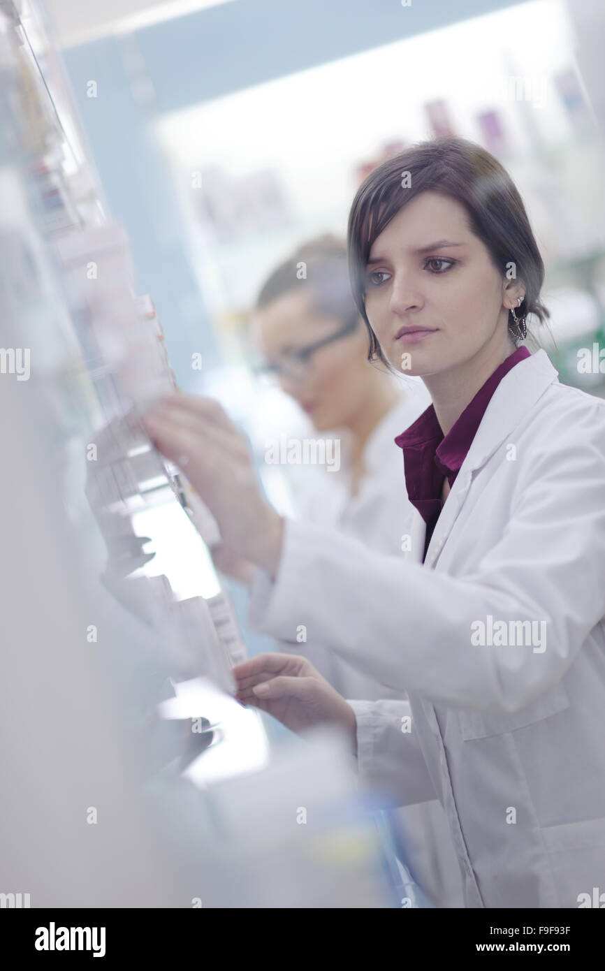 Happy cheerful pharmacist chemist woman standing in pharmacy drugstore ...