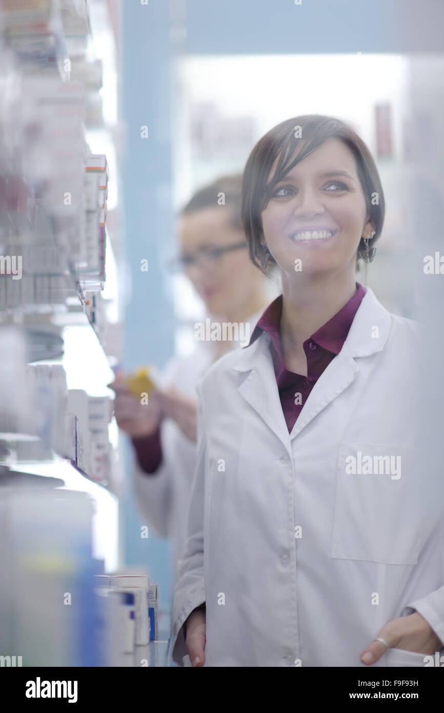 Happy cheerful pharmacist chemist woman standing in pharmacy drugstore ...