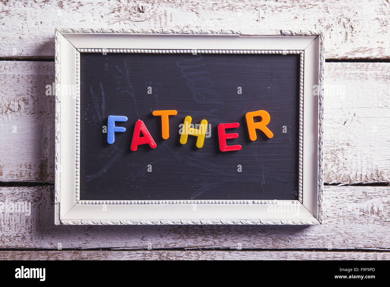 Picture frame with Father sign laid on wooden floor background Stock ...