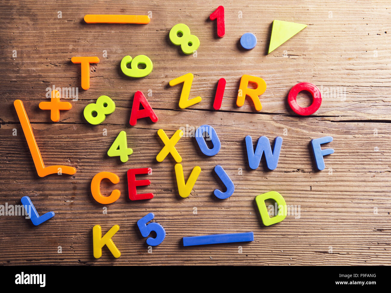 Colorful plastic letters and numbers laid on wooden background Stock ...