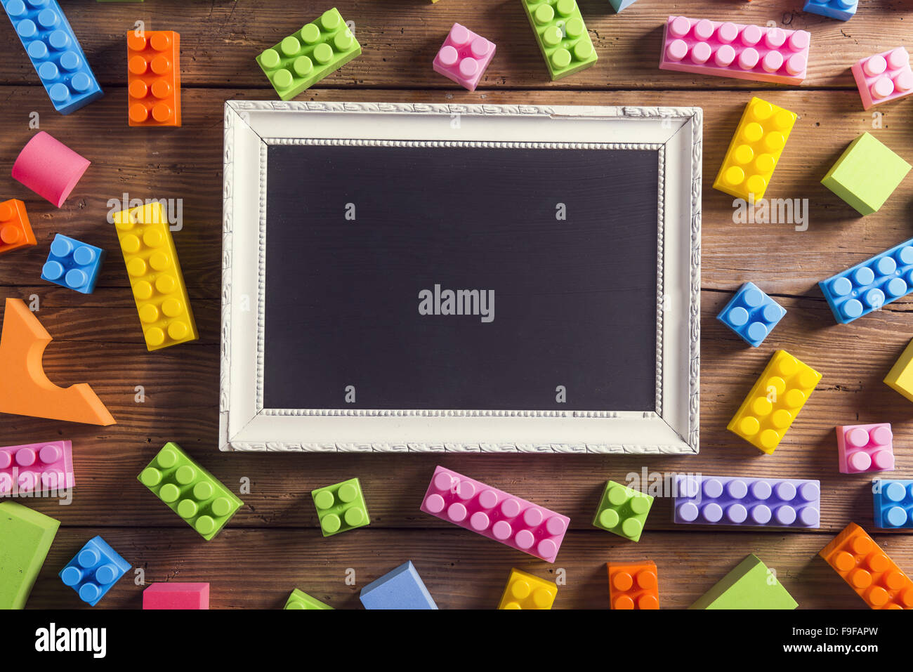 Picture frame and colorful blocks laid on wooden background Stock Photo ...