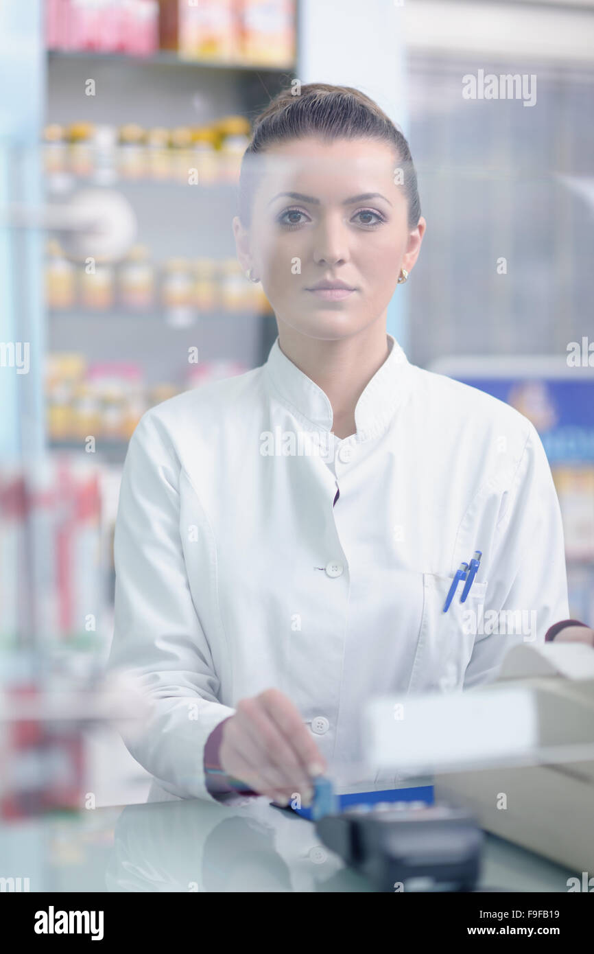 Happy cheerful pharmacist chemist woman standing in pharmacy drugstore ...