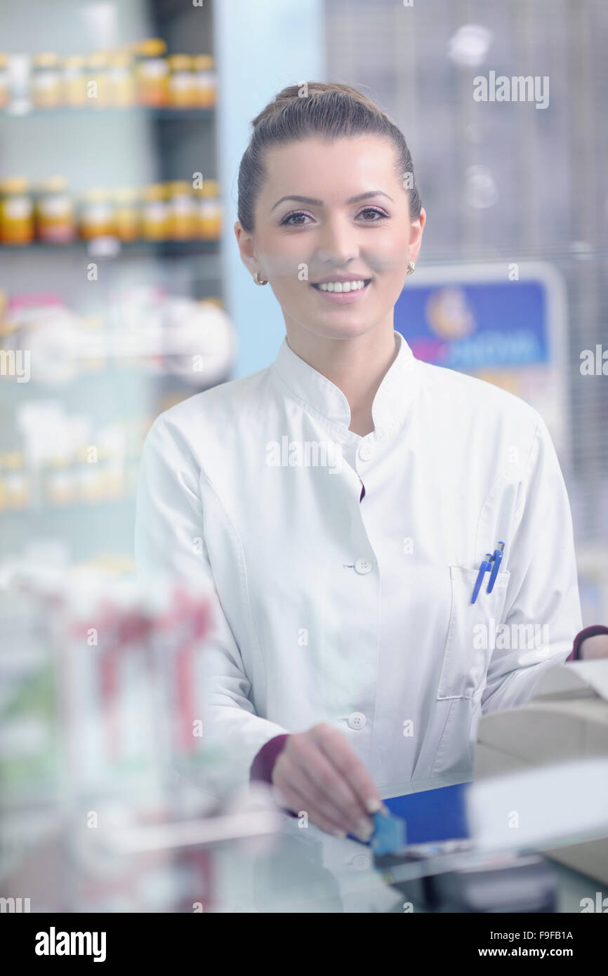 Happy cheerful pharmacist chemist woman standing in pharmacy drugstore ...