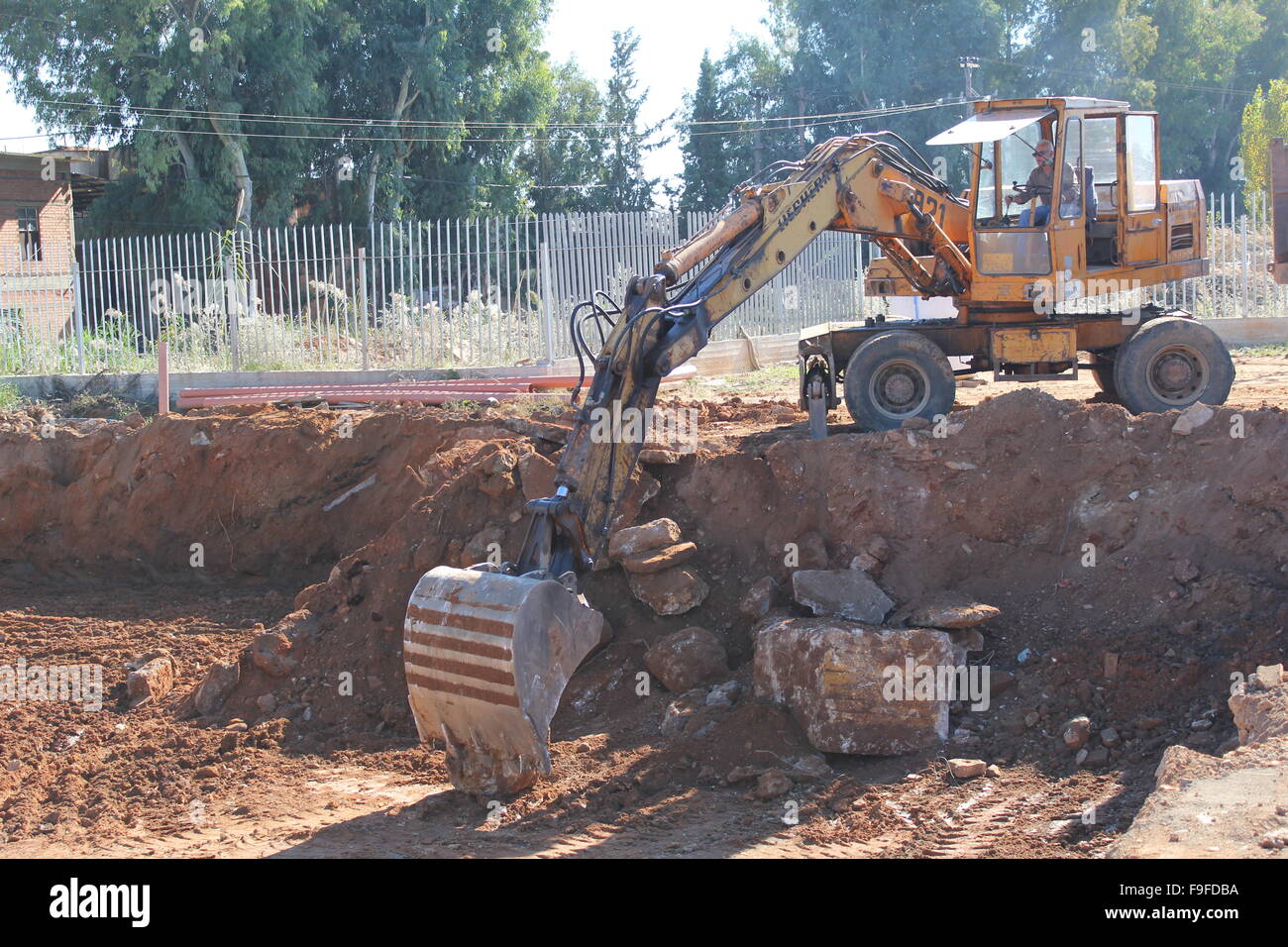 Excavator removing earth from a building site Stock Photo - Alamy