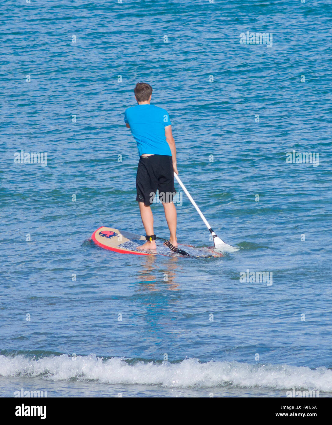 Young 20s on paddle board hi-res stock photography and images - Alamy