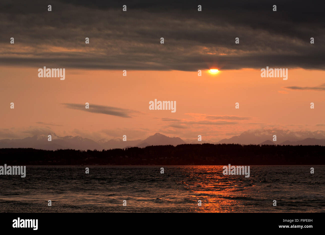 SEATTLE - The sun coming out of the clouds and reflecting on the Puget ...