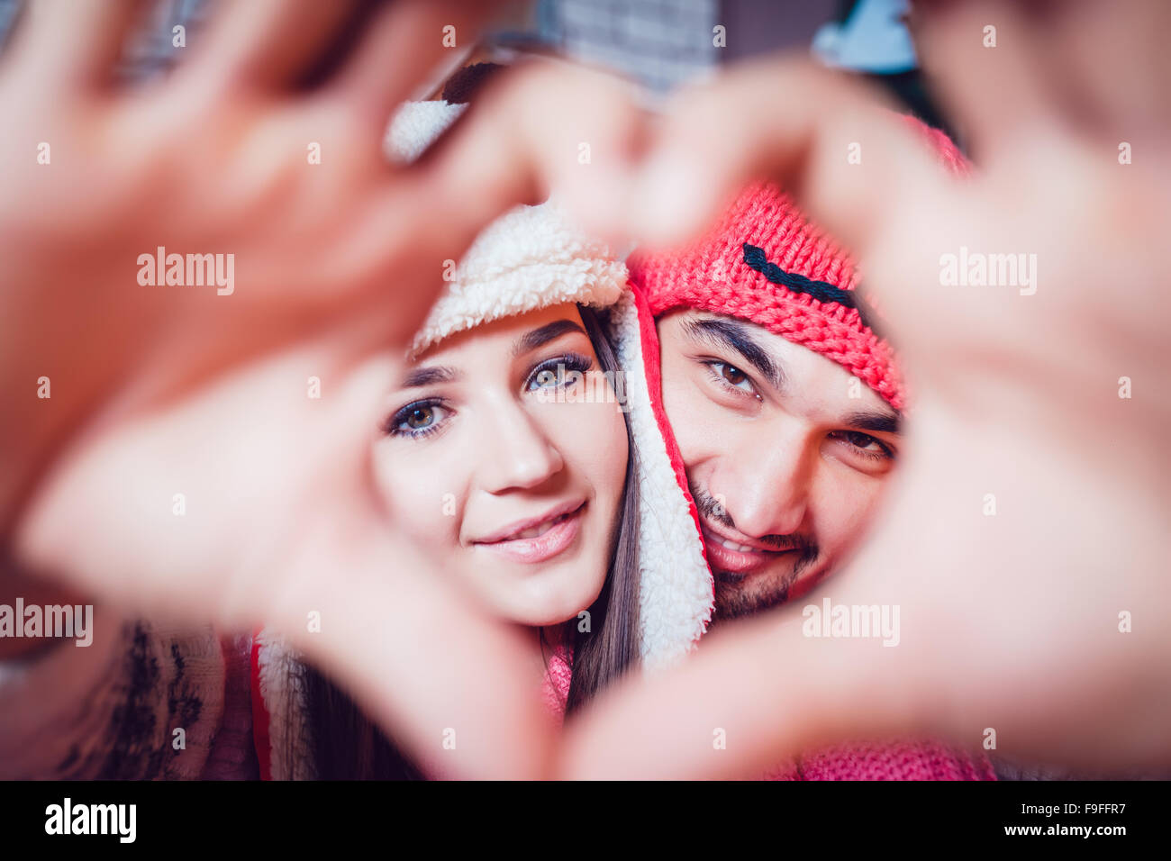 Beautiful Loving couple hands show sign of love Stock Photo - Alamy