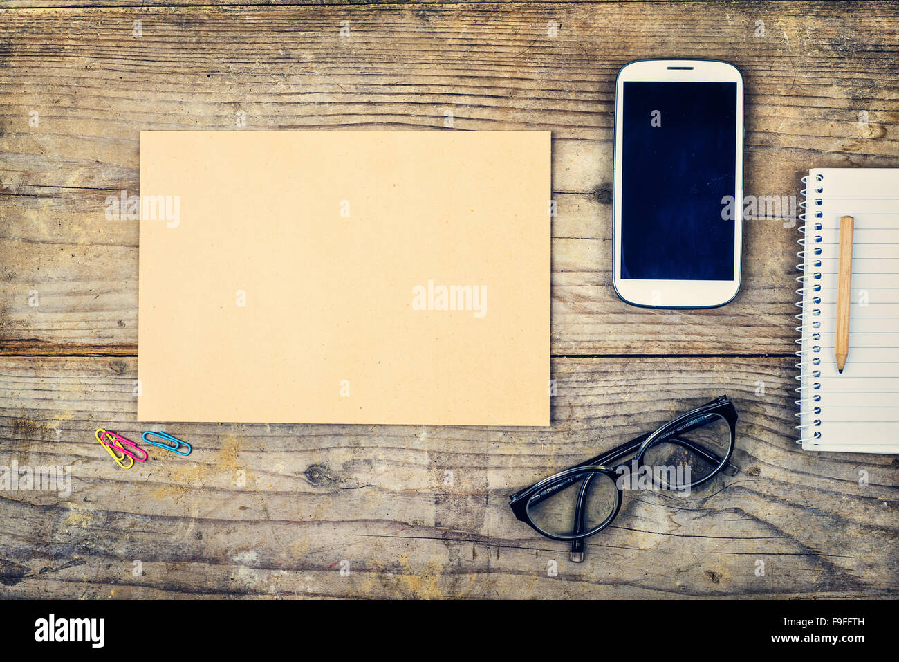 Desktop mix on a wooden office table background. View from above Stock ...
