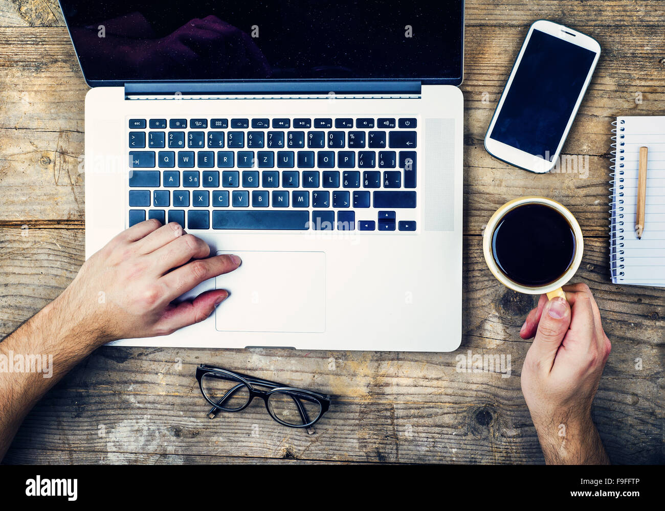 Desktop mix on a wooden office table background. View from above Stock ...