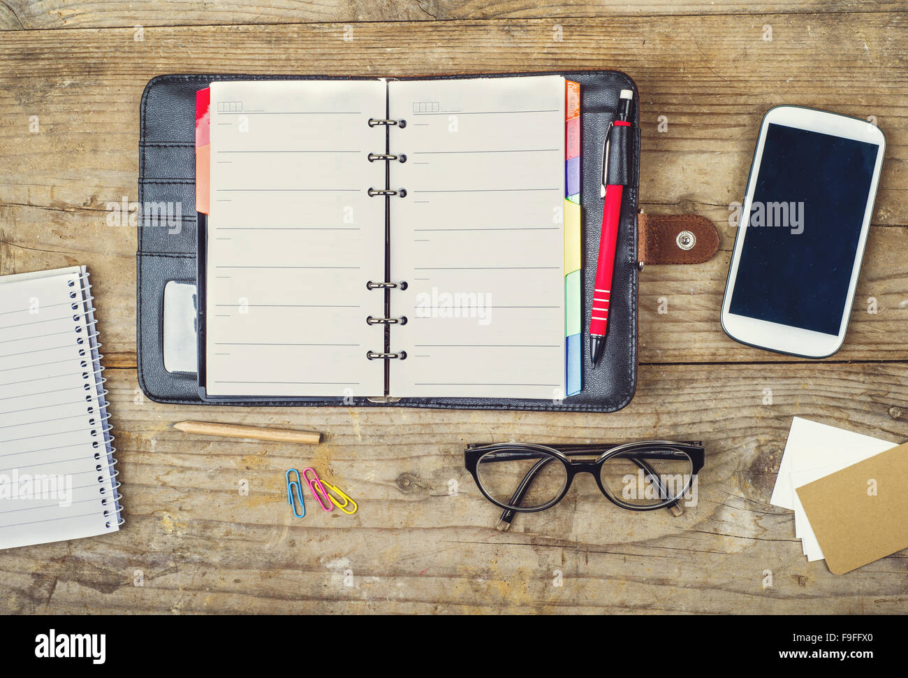 Desktop mix on a wooden office table background. View from above Stock ...