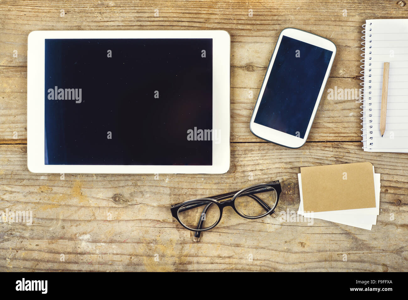 Desktop mix on a wooden office table background. View from above Stock ...