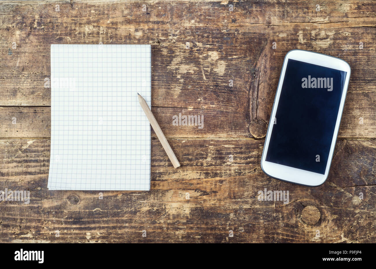 Desktop mix on a wooden office table background. View from above Stock ...