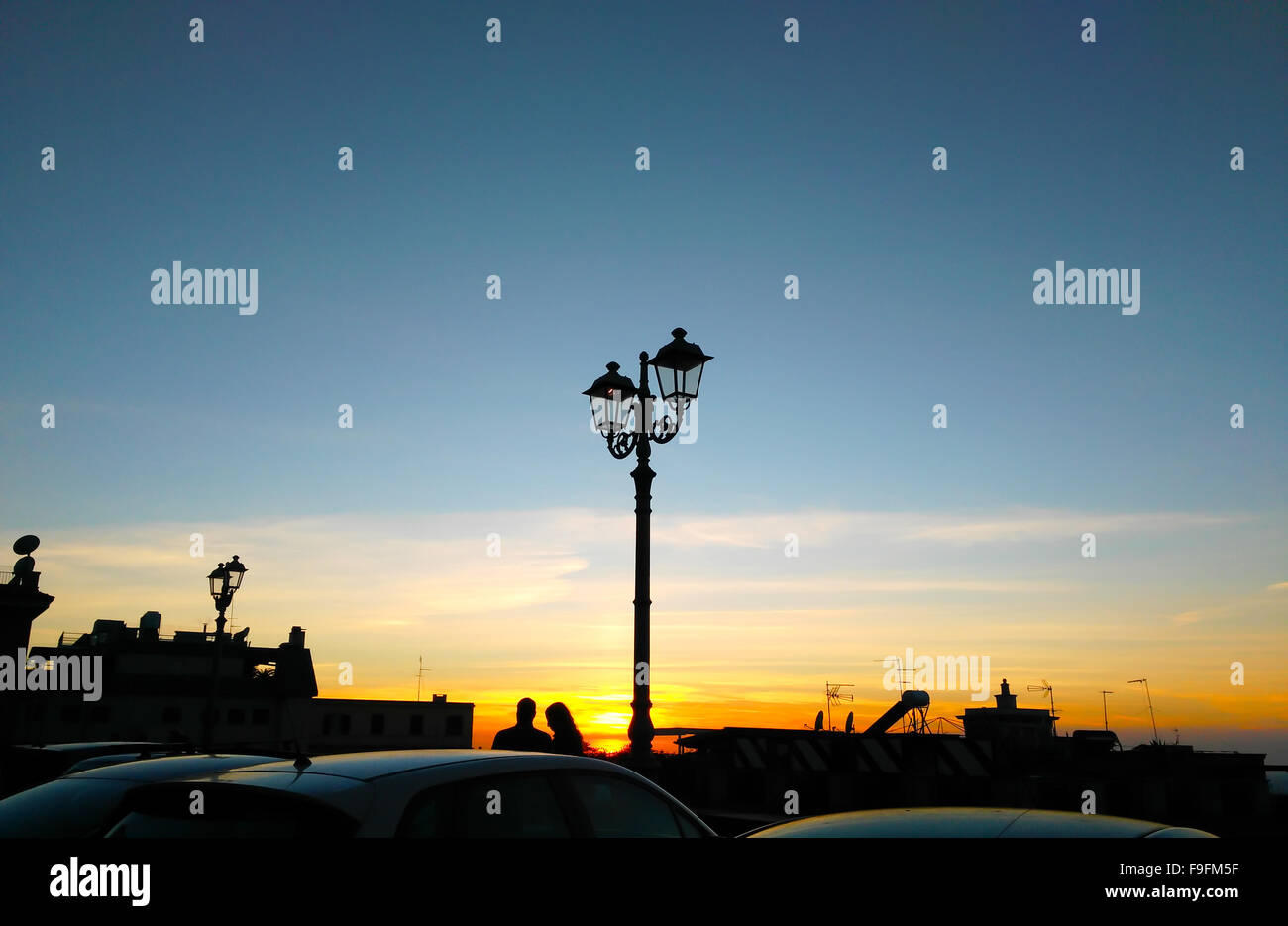 A couple under the streetlamp in the twilight Stock Photo - Alamy