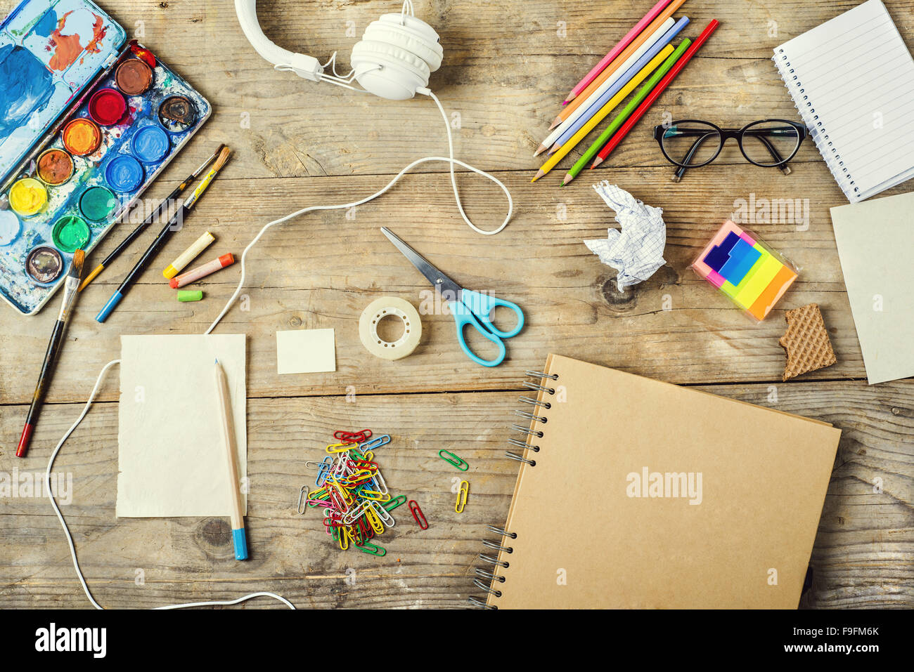 Desk of an artist with lots of stationery objects. Studio shot on ...