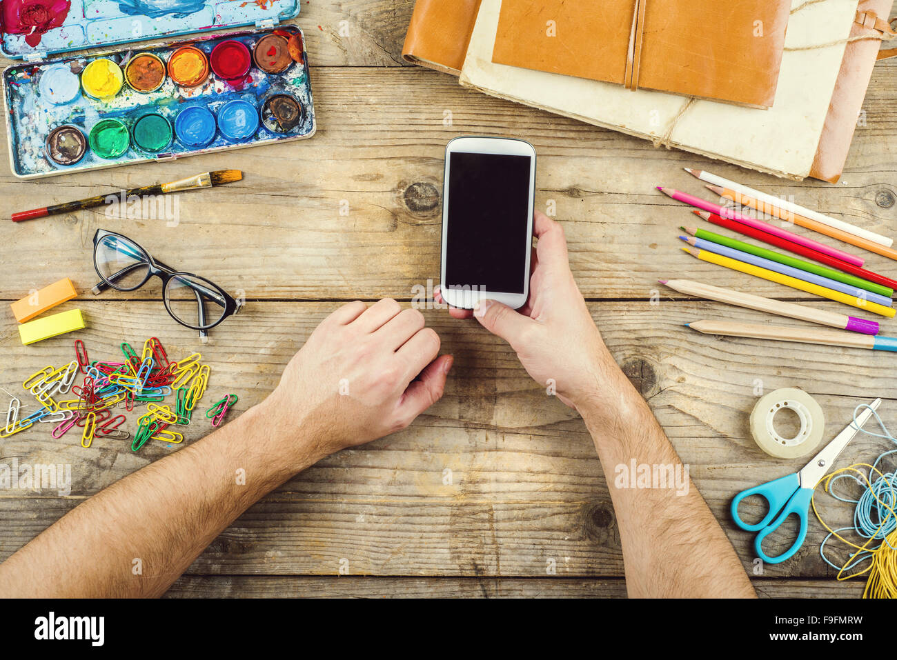 Desk of an artist with lots of stationery objects. Studio shot on ...