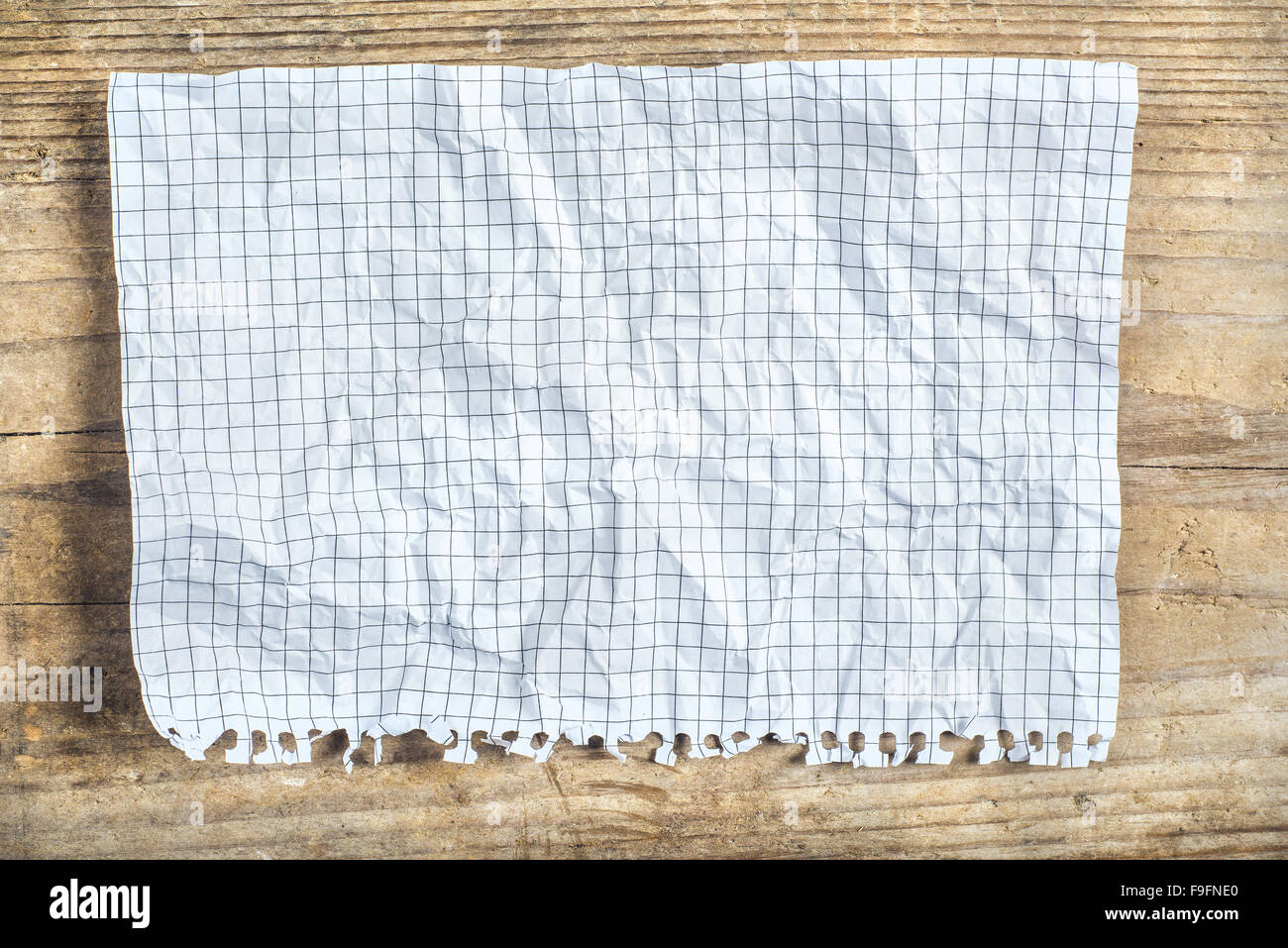 Piece of old rumpled paper on wooden floor background Stock Photo - Alamy