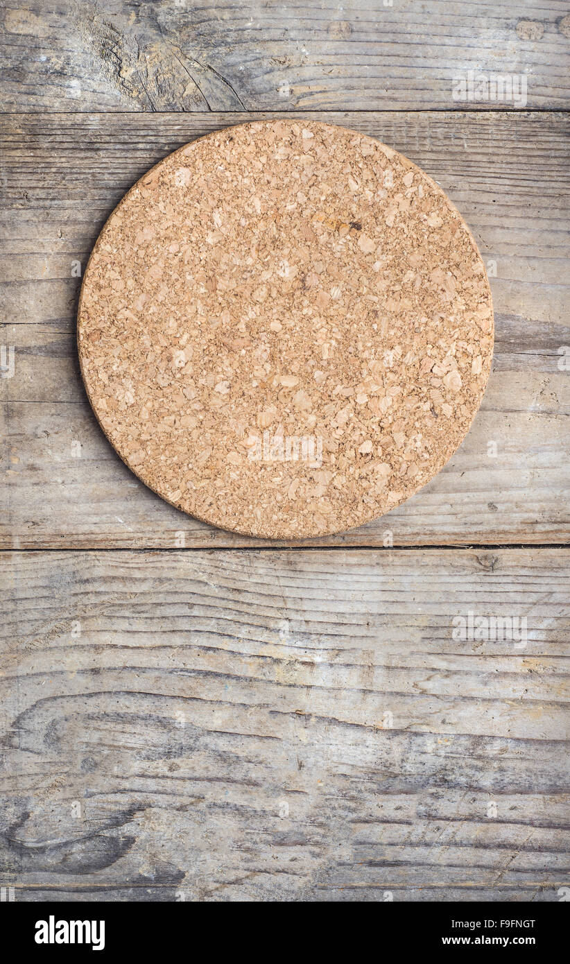 Round cork mat on wooden floor background Stock Photo - Alamy