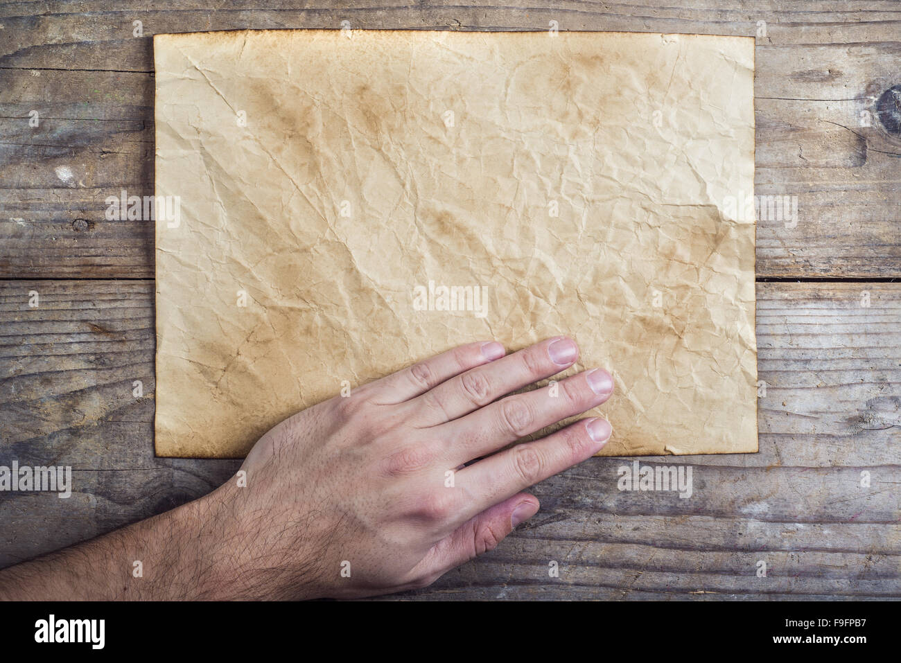 Piece of old rumpled paper on wooden floor background Stock Photo - Alamy
