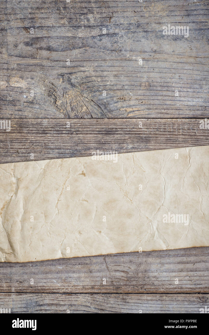 Piece of old rumpled paper on wooden floor background Stock Photo - Alamy