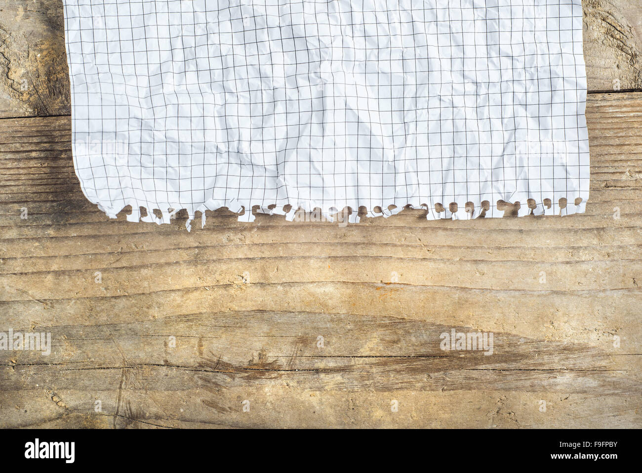 Piece of old rumpled paper on wooden floor background Stock Photo - Alamy